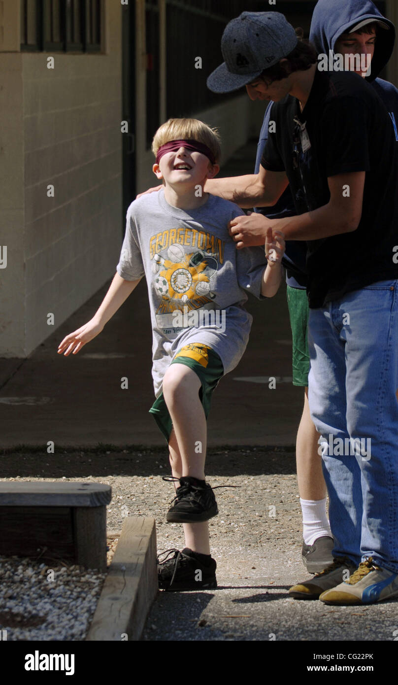 Logan Elkins (cq, left), 11, is led by Sierra High School student Zach ...