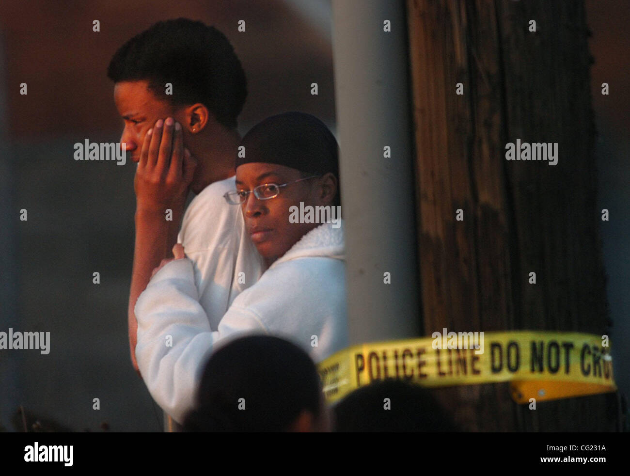 Darrell Clark, 17, left, is comforted by his mother Sonjia Clark, (Cq ...