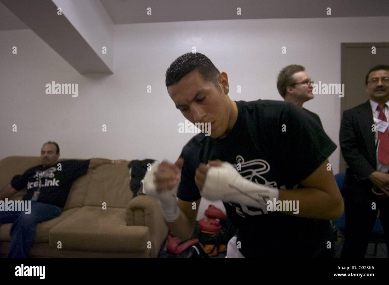 Boxer Vicente Escobedo (cq-forground) warms up in the dressing room ...