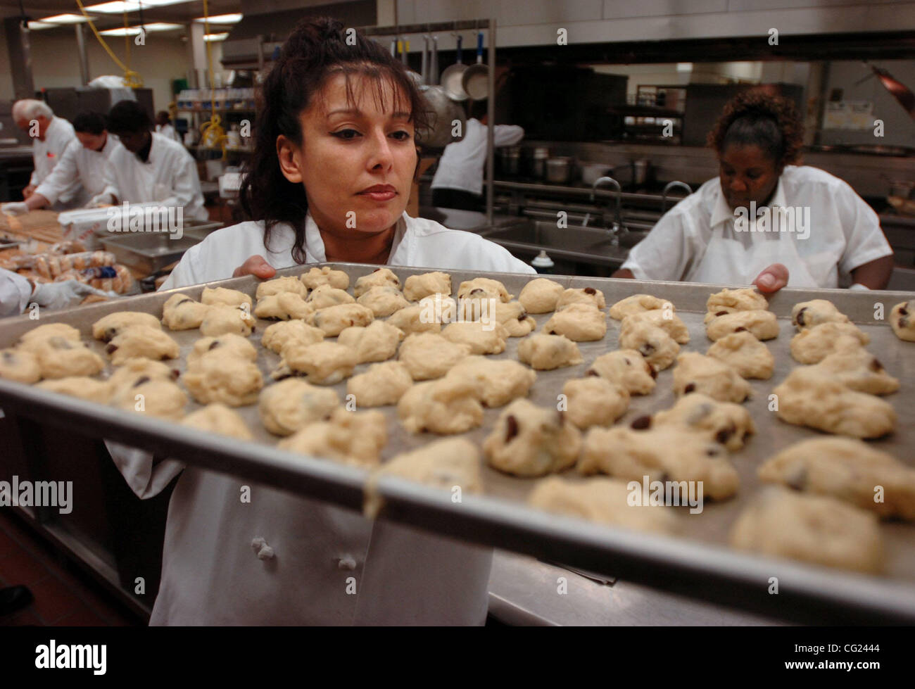 lede -- Celeste Redon, with Classique Catering, loads a tray of Fried ...