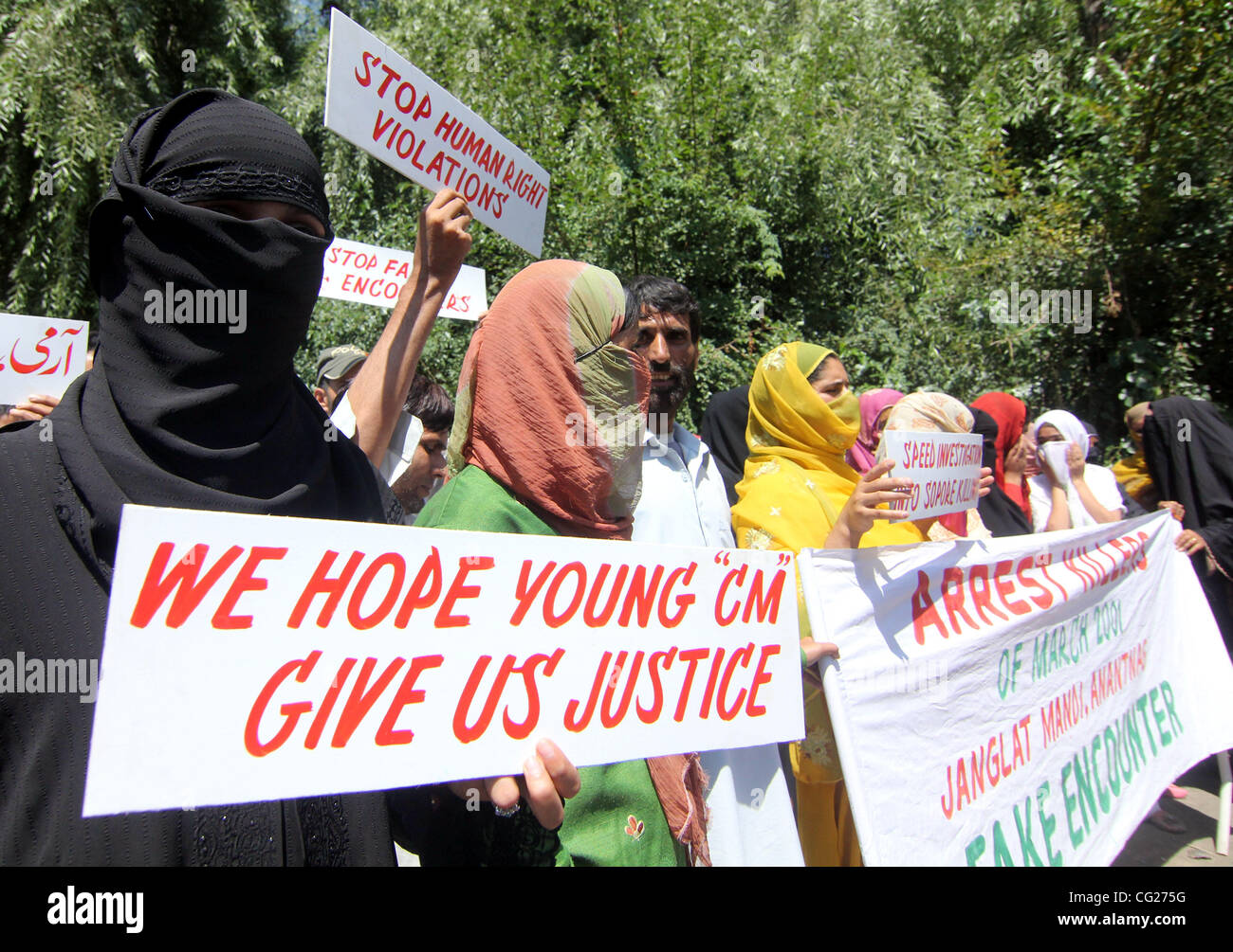 Kashmiri muslim women hold plycard during protest against the killings ...