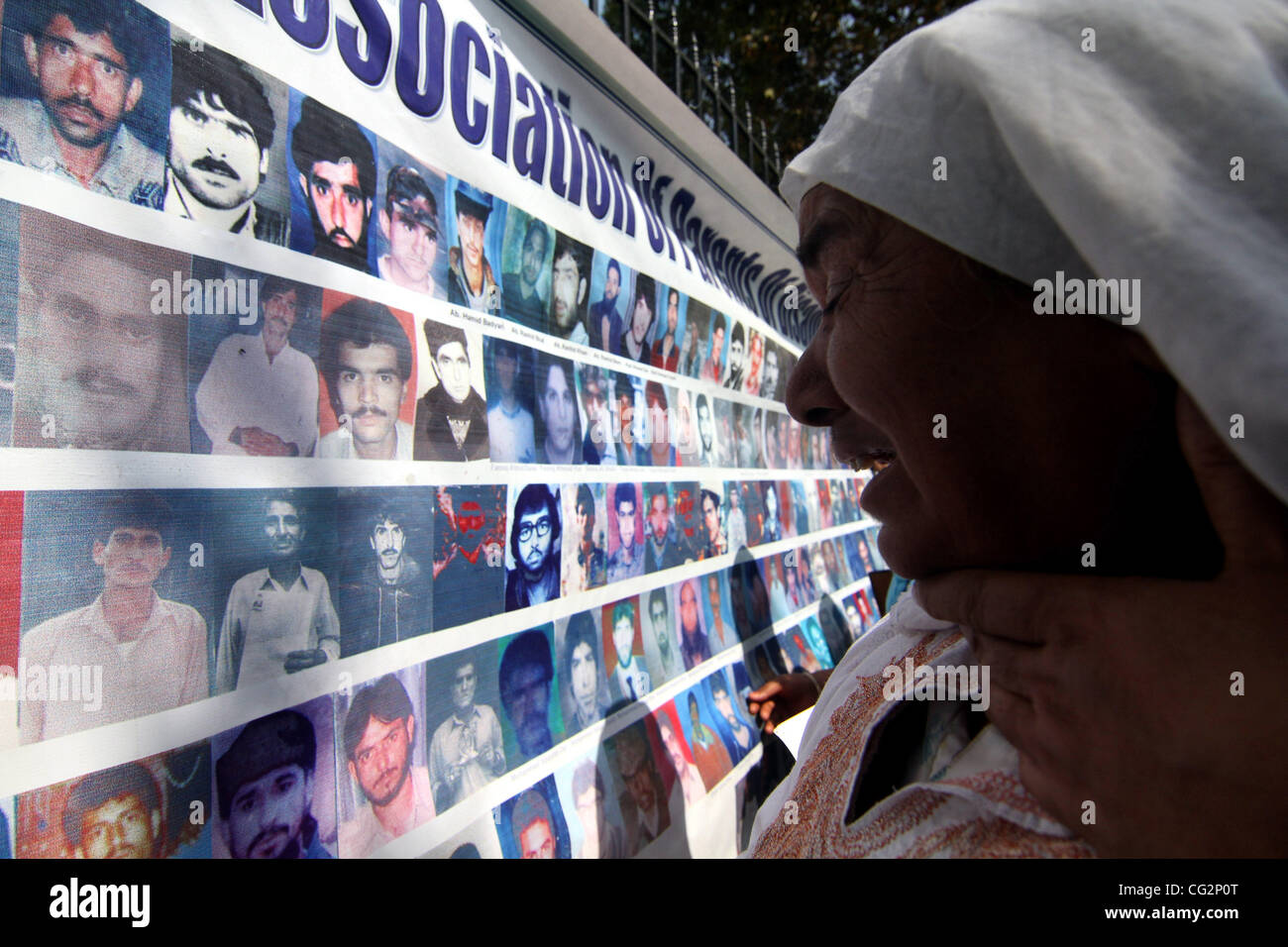 A mother of a missing person weeps as she looking photographer of her ...