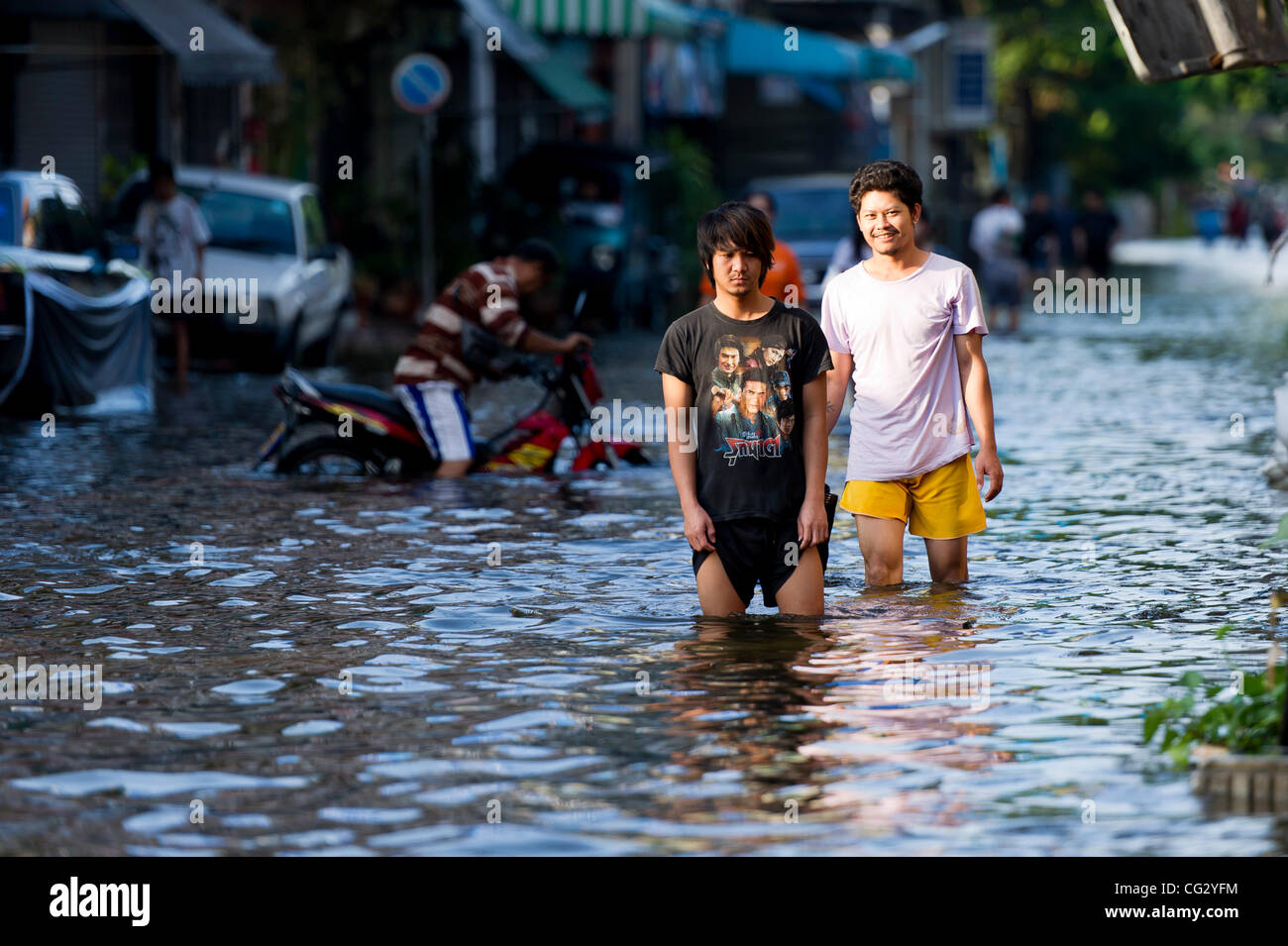 People walk through flooded street hi-res stock photography and images ...