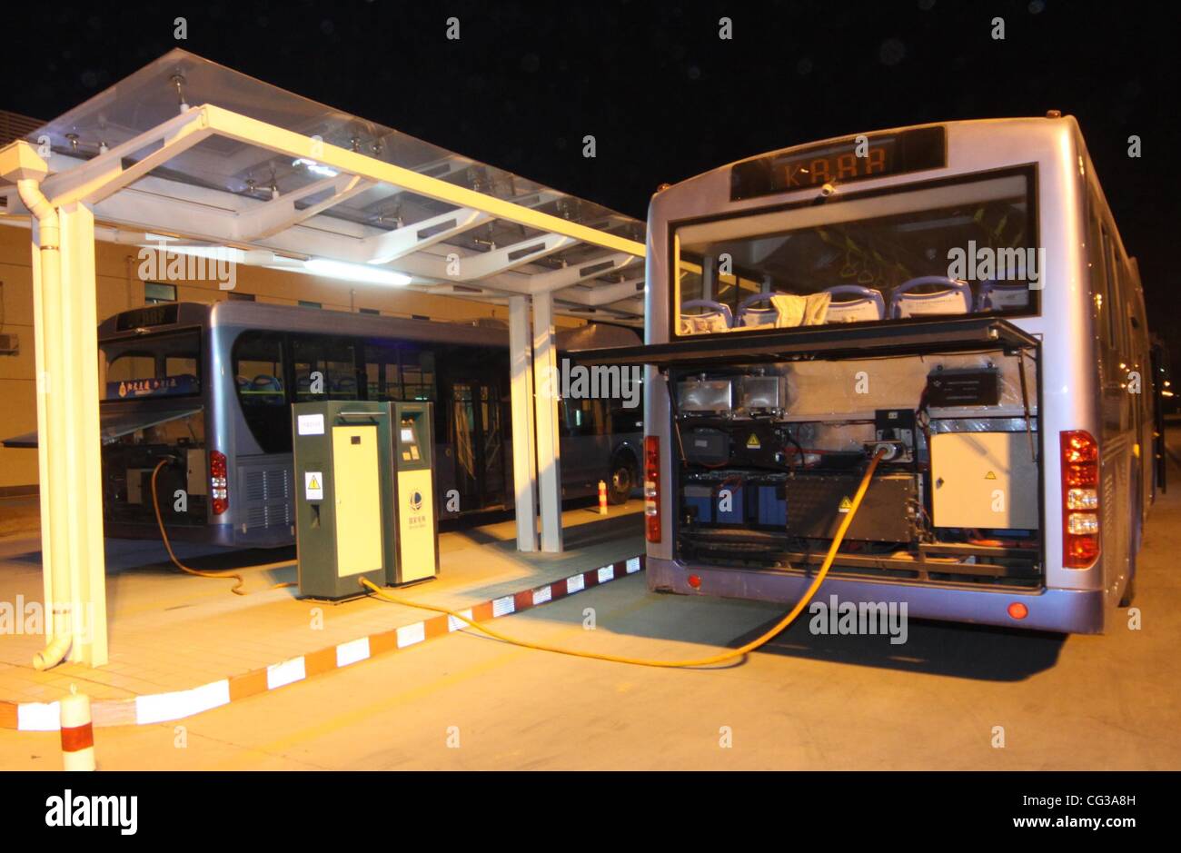 Electric Buses Electric buses recharge their batteries at a bus depot ...