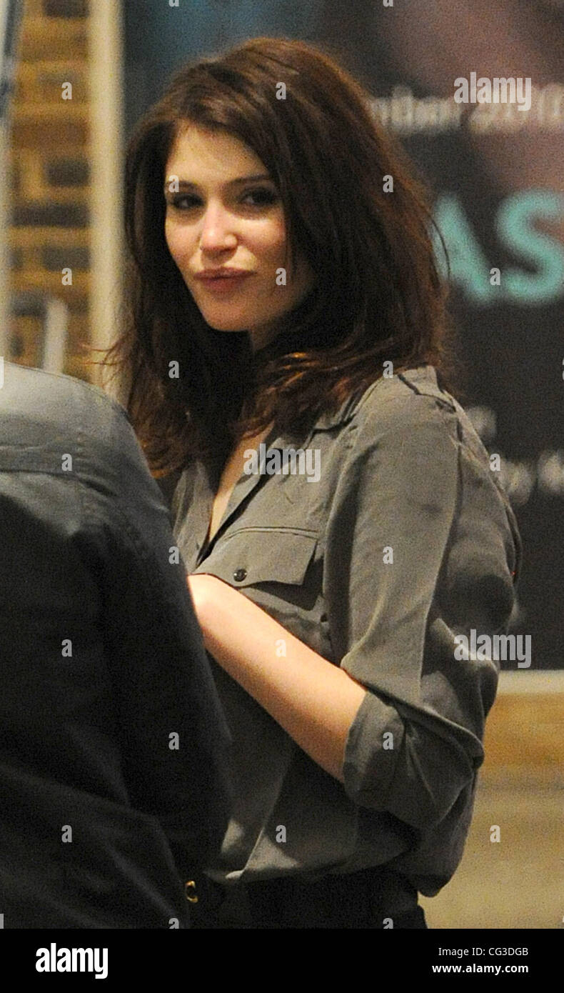 Gemma Arterton shares a rather animated conversation with friends ...