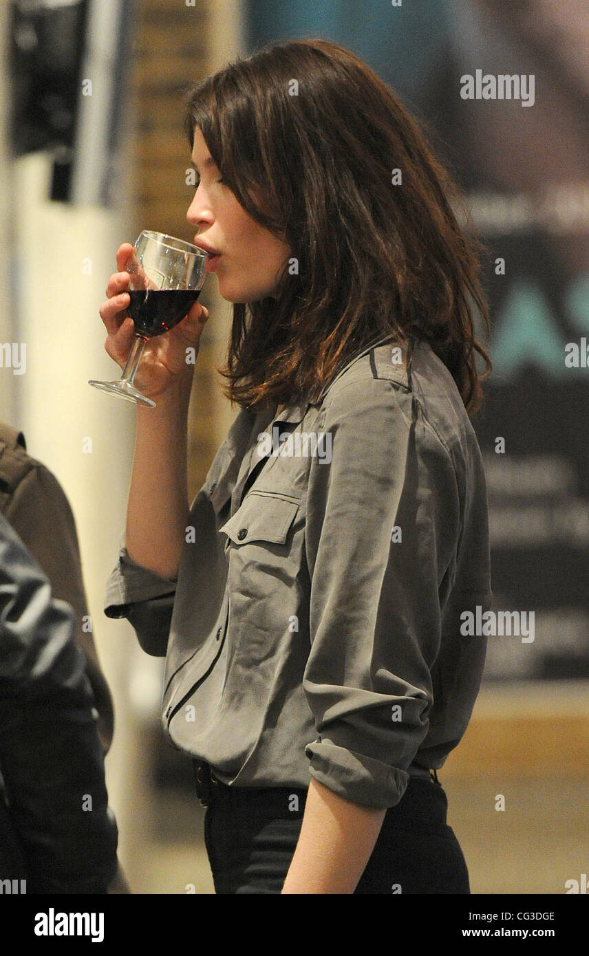 Gemma Arterton shares a rather animated conversation with friends ...