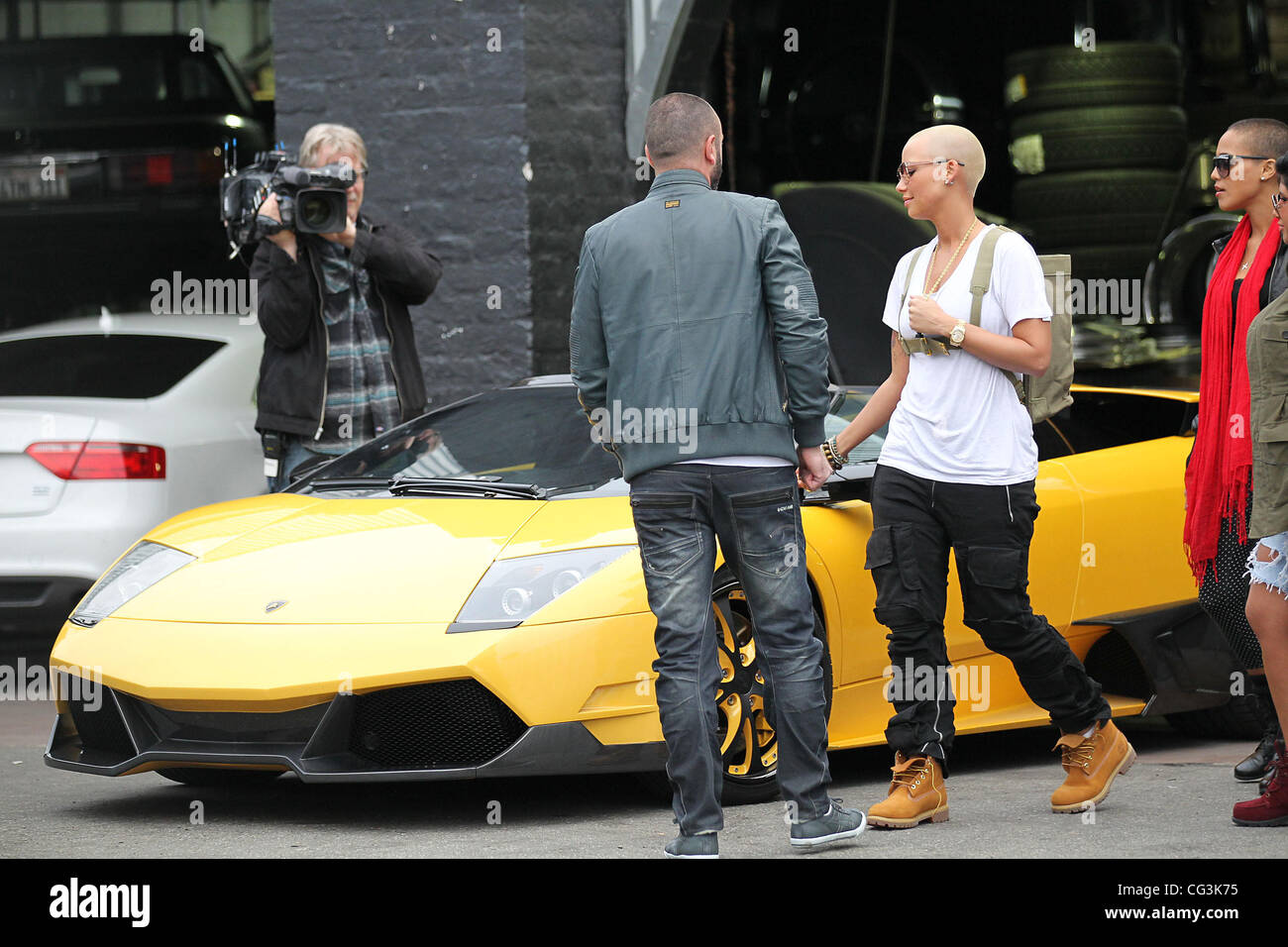 Amber Rose looking at a lamborghini sports car at Platinum Motorsports ...