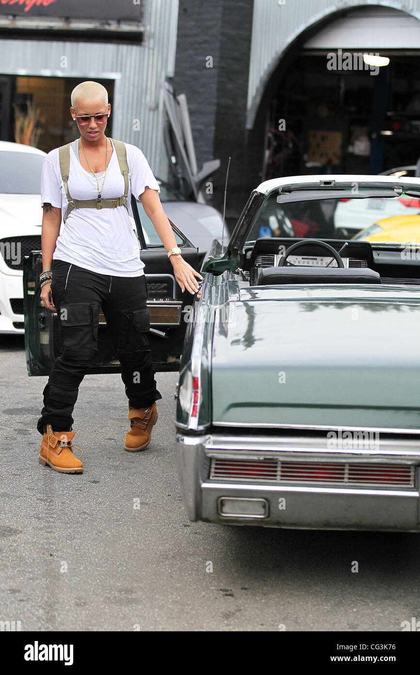 Amber Rose looking at customised cars at Platinum Motorsports in ...