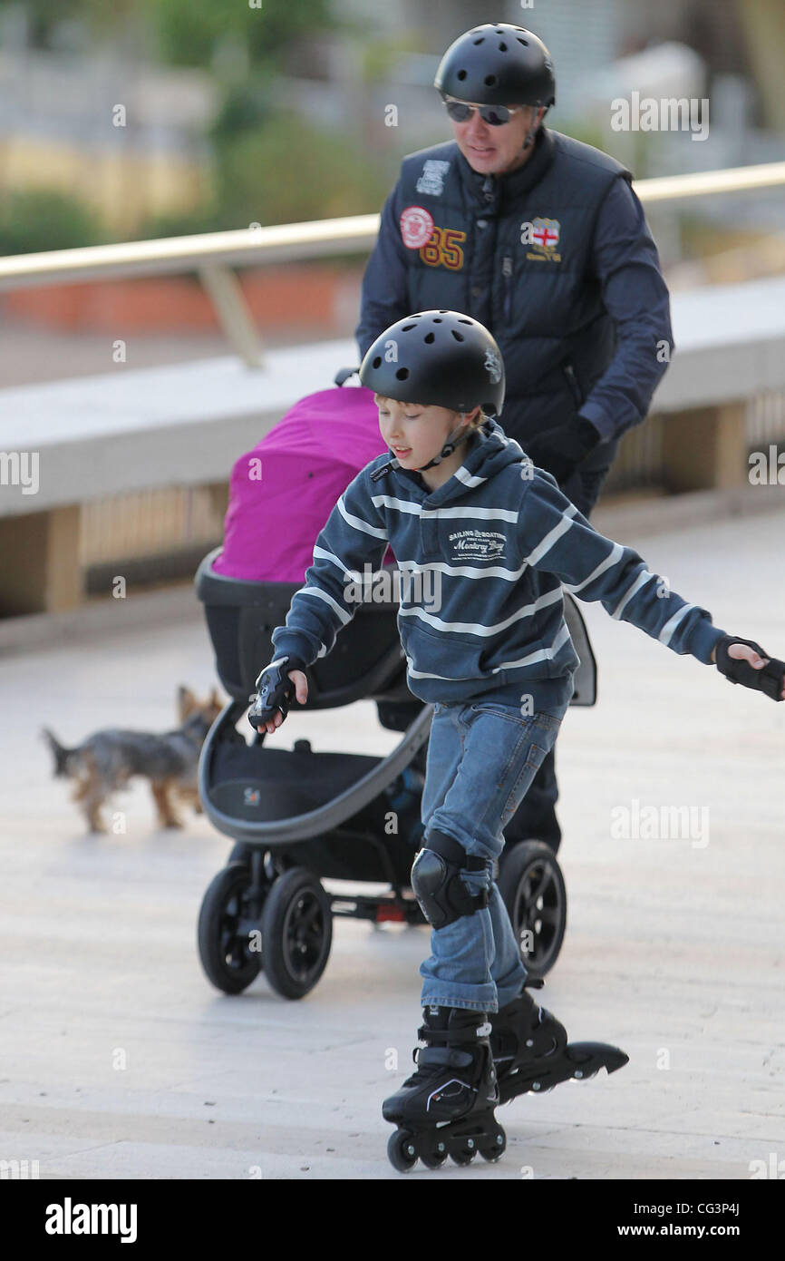 Mika Hakkinen pushes his daughter Ella in her pram whilst rollerblading ...