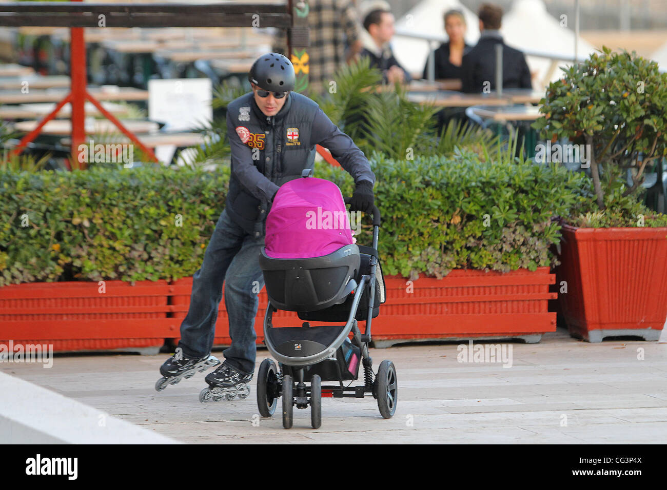 Mika Hakkinen pushes his daughter Ella in her pram whilst rollerblading ...