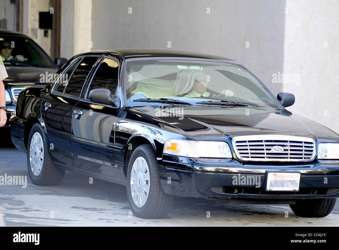 Lindsay Lohan covered up in the back seat of a Ford Crown Victoria ...