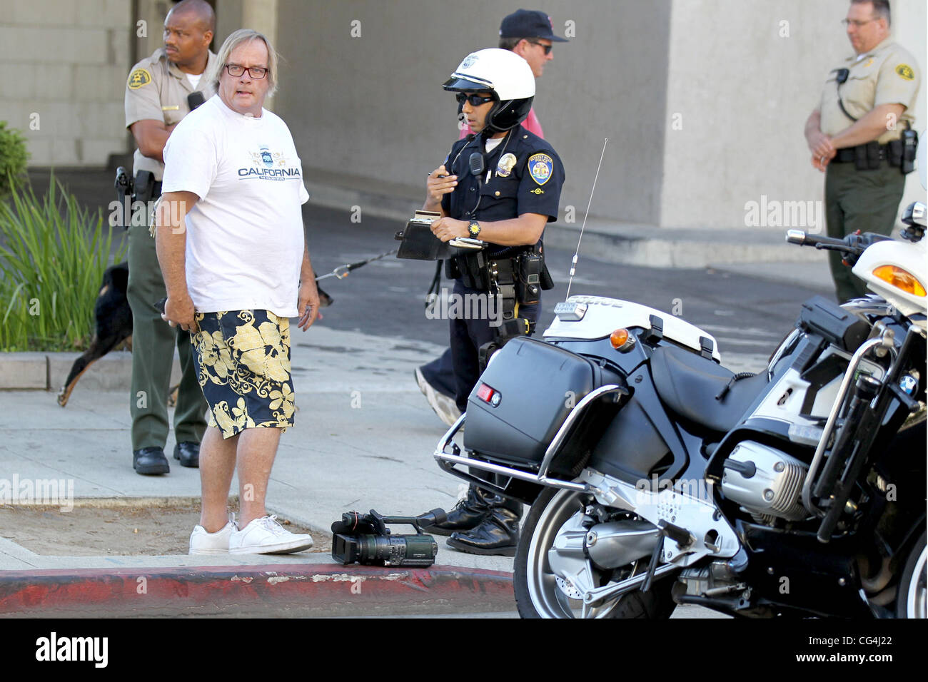 Paparazzo Richard Terry receiving a ticket for jaywalking outside ...