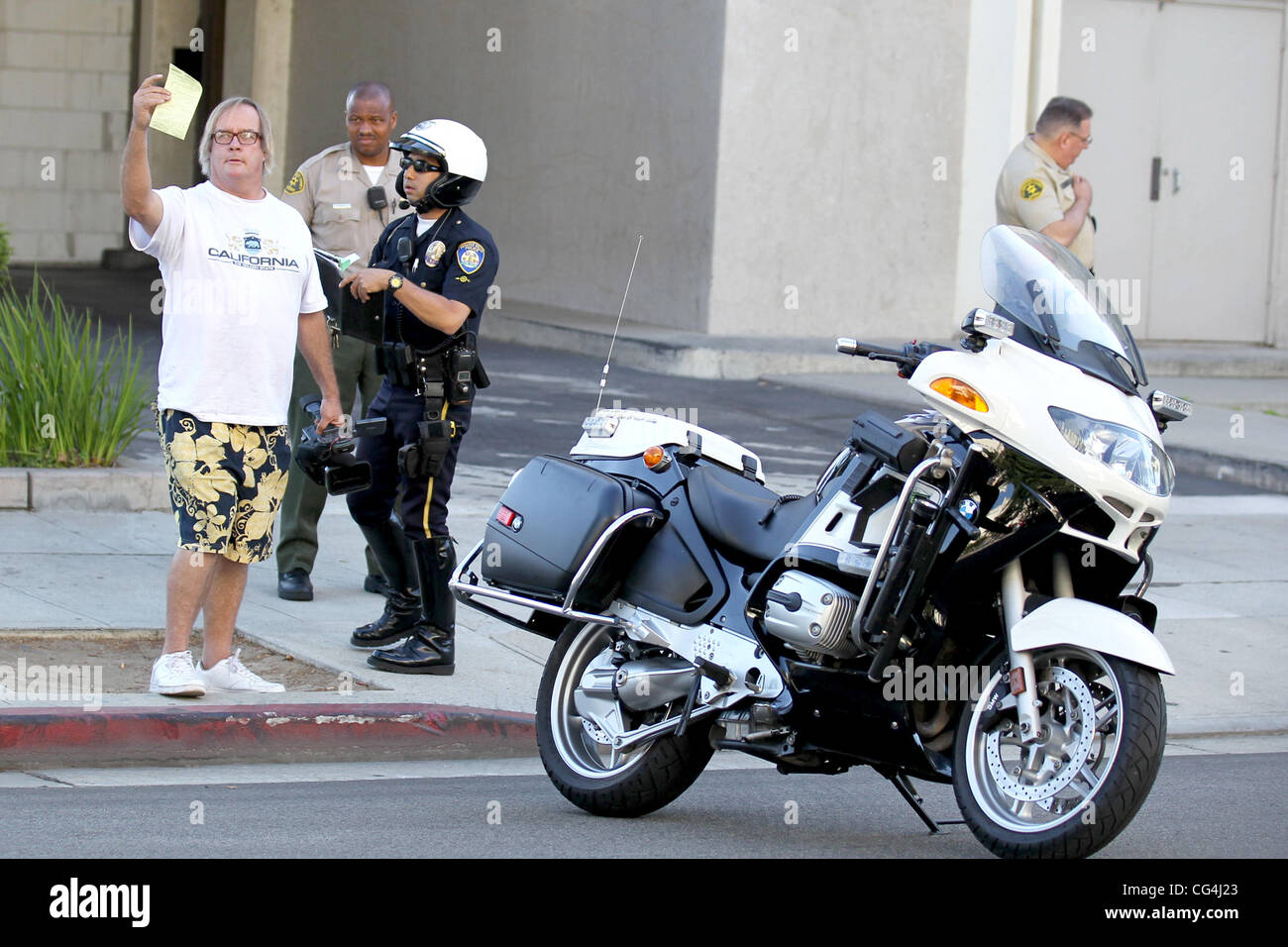 Paparazzo Richard Terry receiving a ticket for jaywalking outside ...