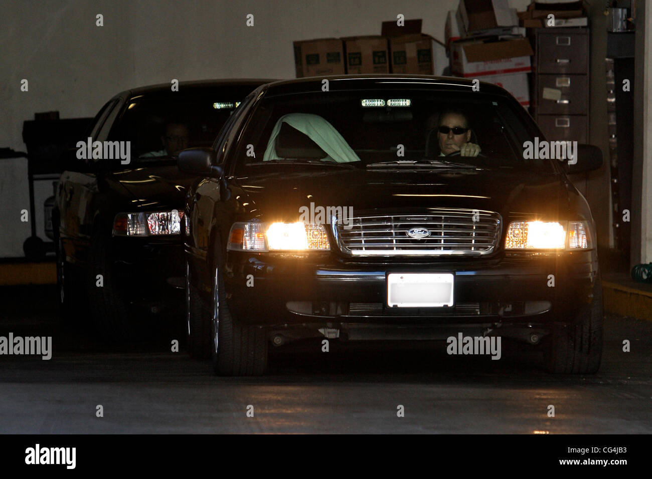 Lindsay Lohan covered up in the back seat of a Ford Crown Victoria ...