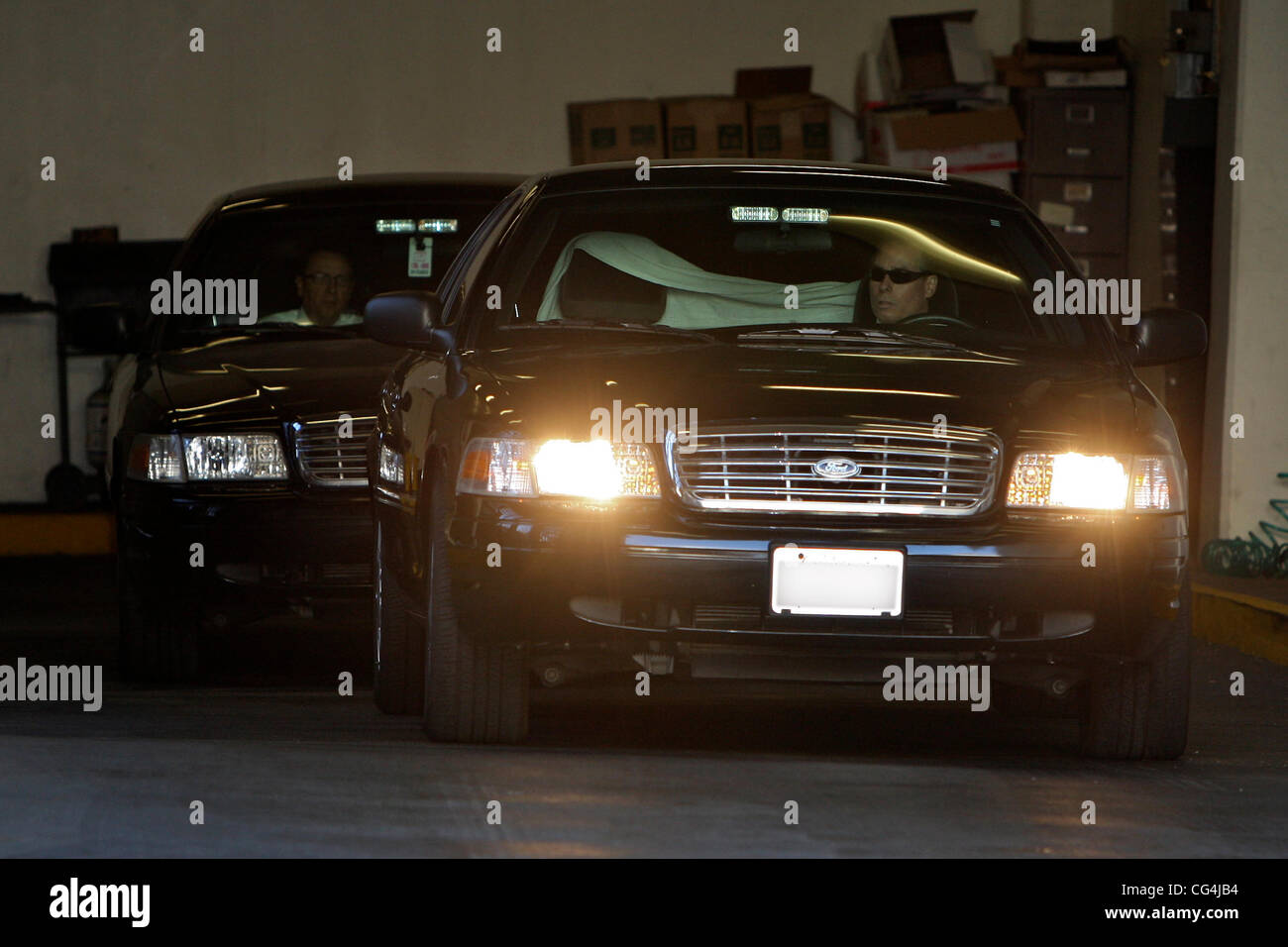 Lindsay Lohan covered up in the back seat of a Ford Crown Victoria ...