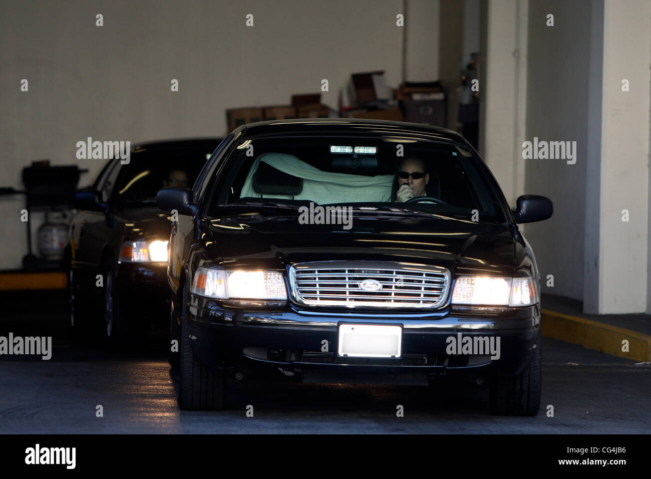 Lindsay Lohan covered up in the back seat of a Ford Crown Victoria ...