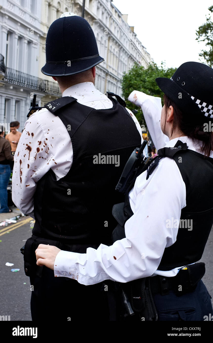 Police woman helps clean up policeman hi-res stock photography and ...
