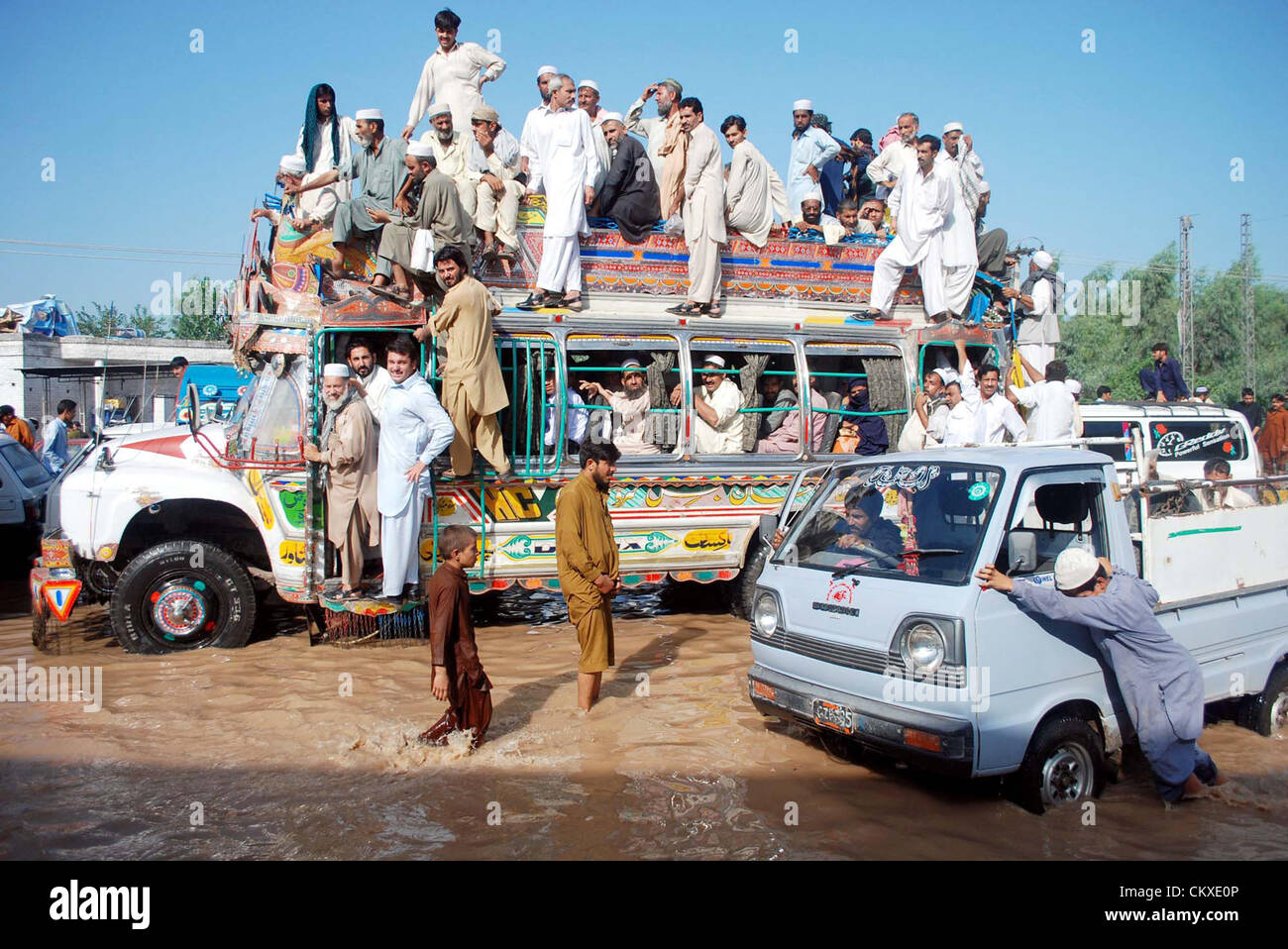 Motorists pass through flood water during heavy downpour of Monsoon ...
