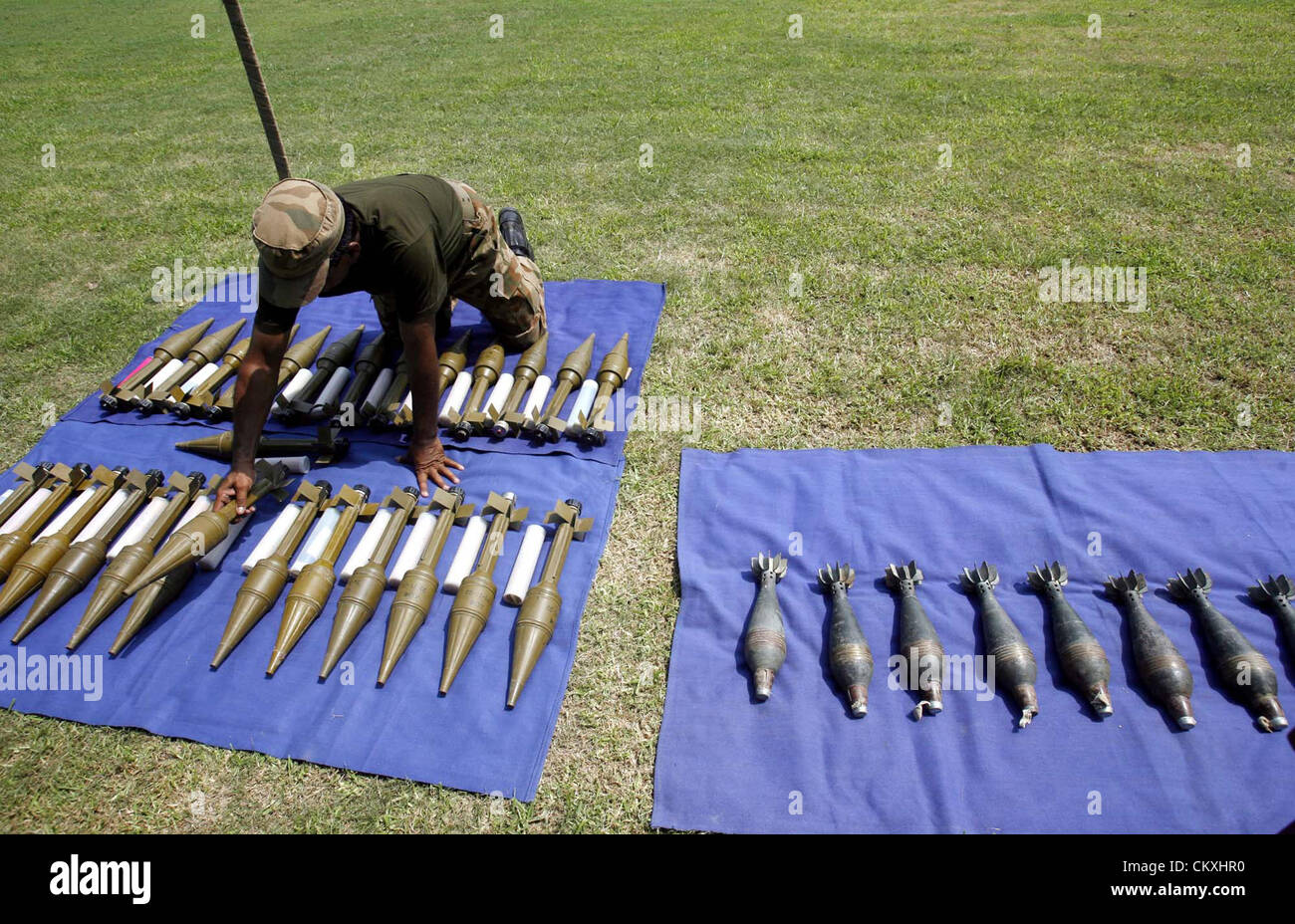 Army officials show seized arms and ammunition, which were recovered ...