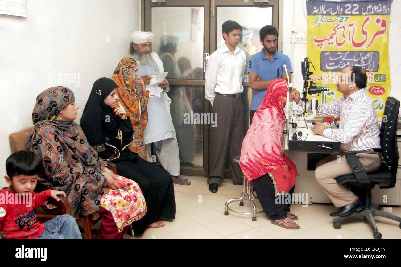 LAHORE, PAKISTAN, AUG 29: Dr.Ijaz Butt examines patients during Madina ...