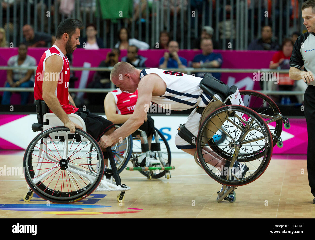 USA's William Waller uses a Turkish player's wheelchair to right ...