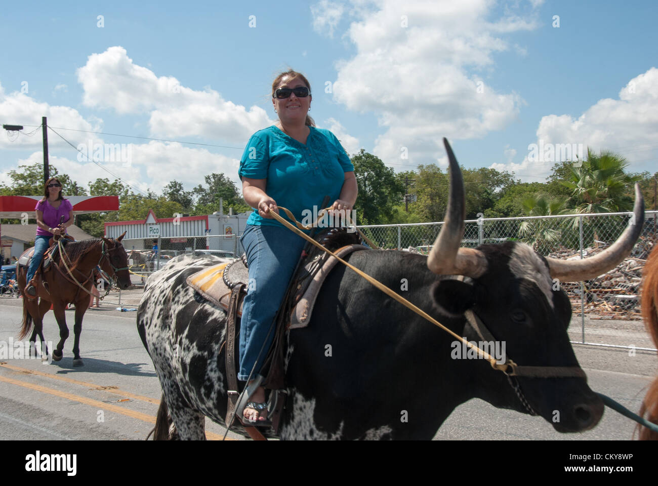 Woman riding longhorn in bandera hi-res stock photography and images ...