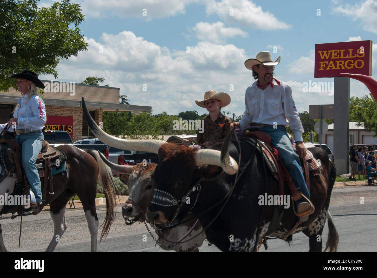 1 September 2012 Bandera, Texas, USA - A father and son ride longhorn ...
