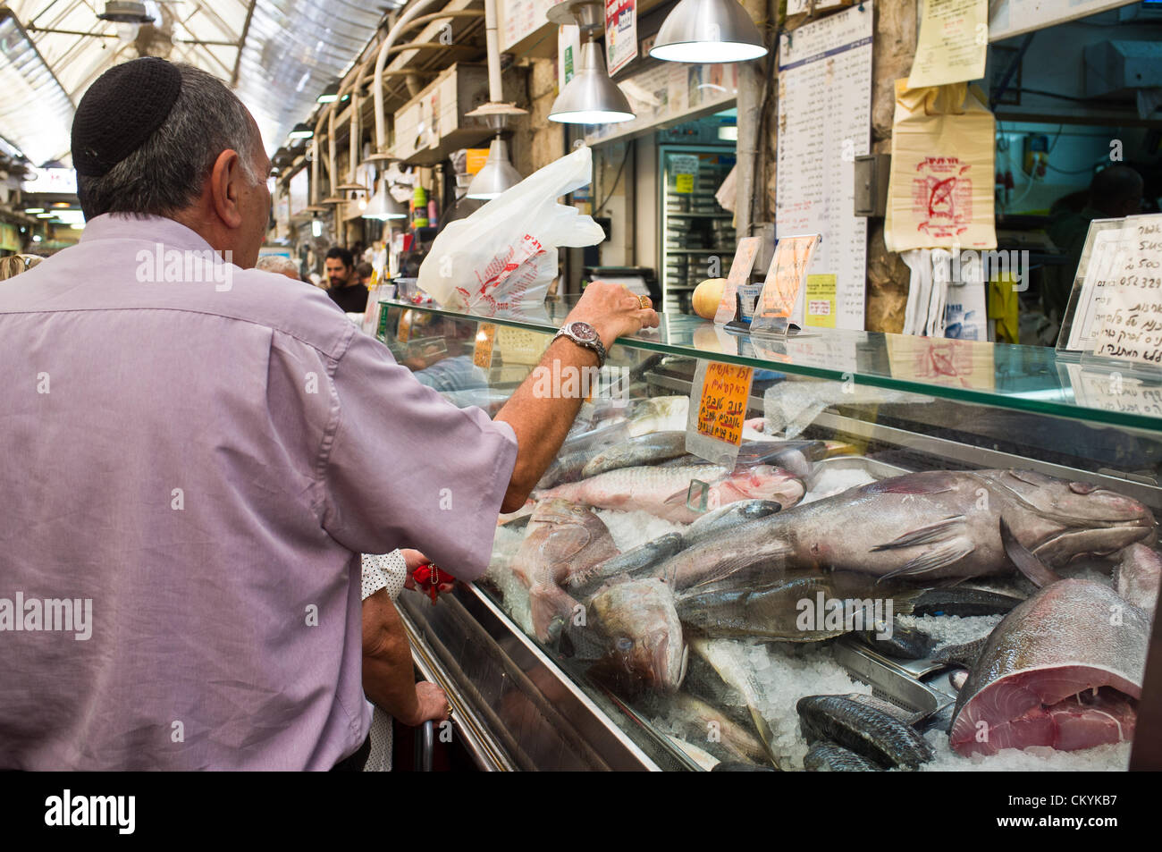 A Jewish religious man, with a yarmulka covering his head, purchases ...