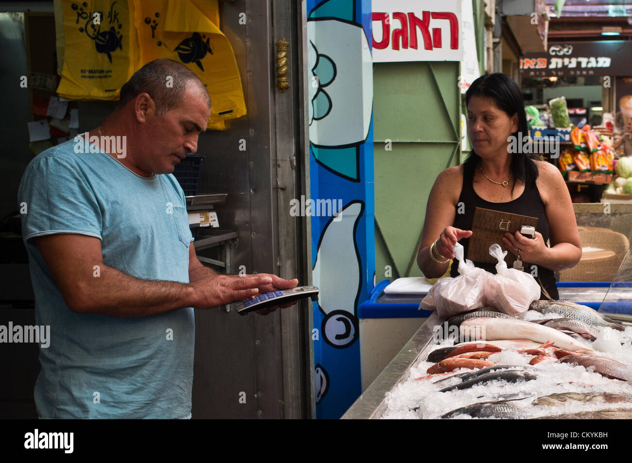 A woman purchases fresh fish at the Mahane Yehuda Market. Jerusalem ...