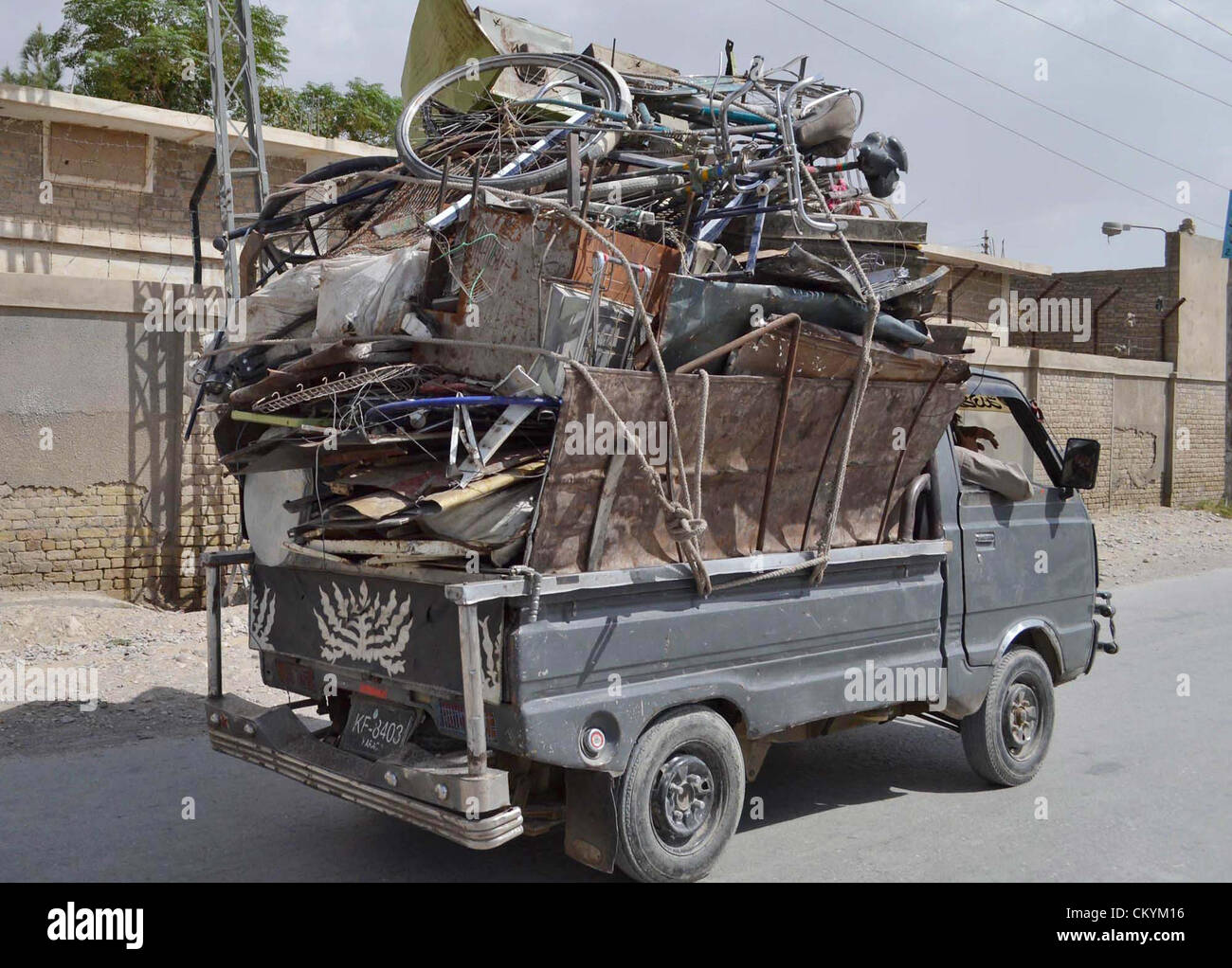 A vehicle that overload with scrap moves towards his destination ...