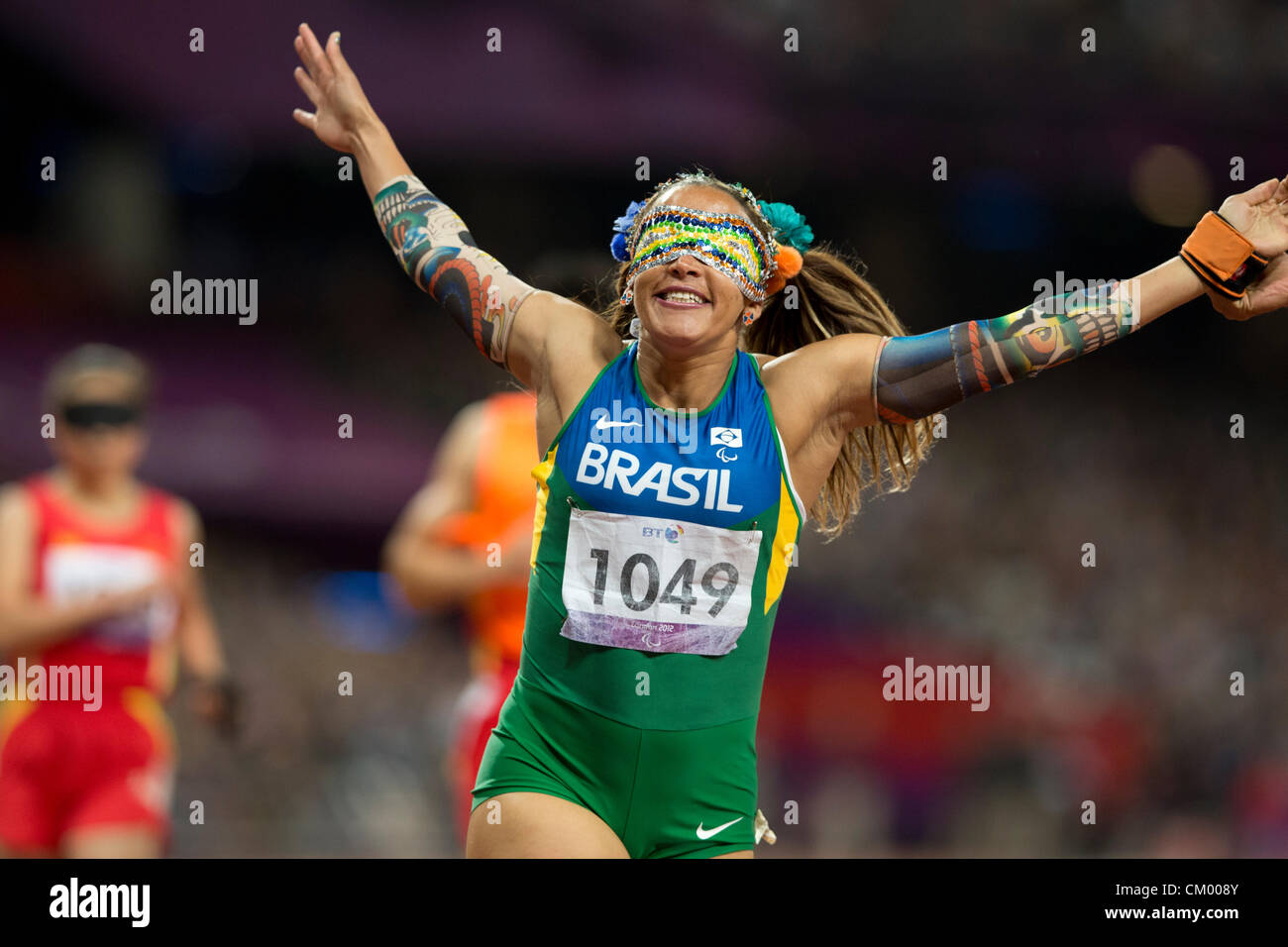 Blind sprinter Terezinha Guilhermina of Brazil waves to the crowd after ...