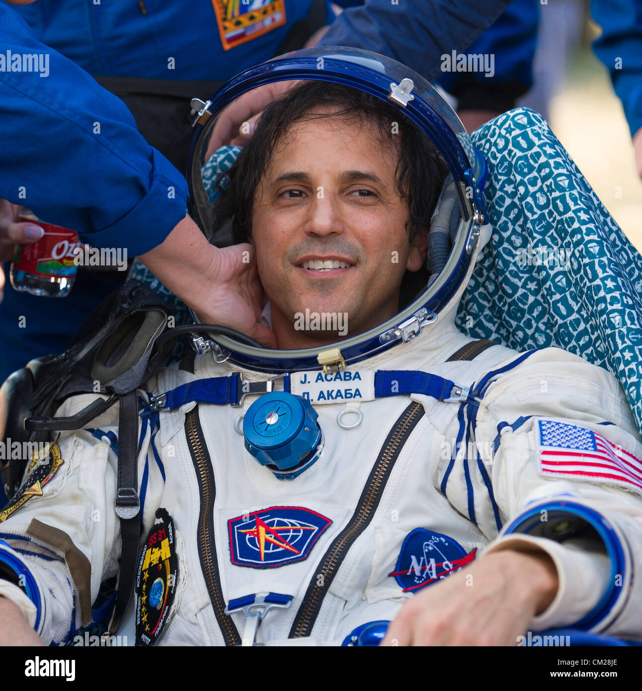 Expedition 32 NASA Flight Engineer Joe Acaba is attended to by crew ...