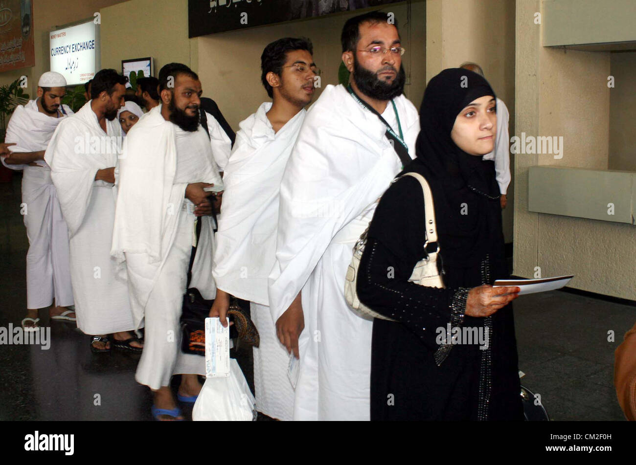 Pakistani pilgrims stand in a queue as they depart for the Annual Hajj ...