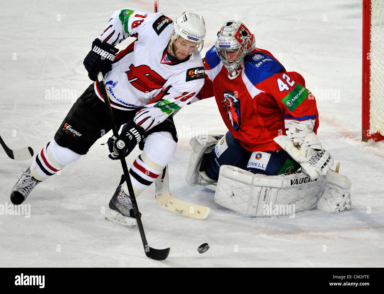 Andrey Ivanov of Omsk (left) and Lev Praha goalkeeper Tomas Popperle ...