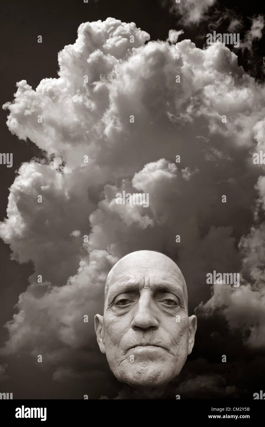 Tired, tortured face of a man on a background of clouds bursting Stock ...