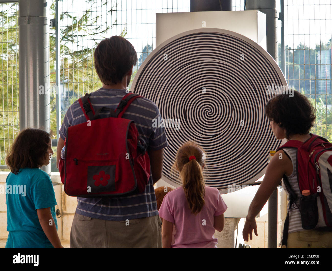 A family experiences a spinning dial with painted pattern at the ...
