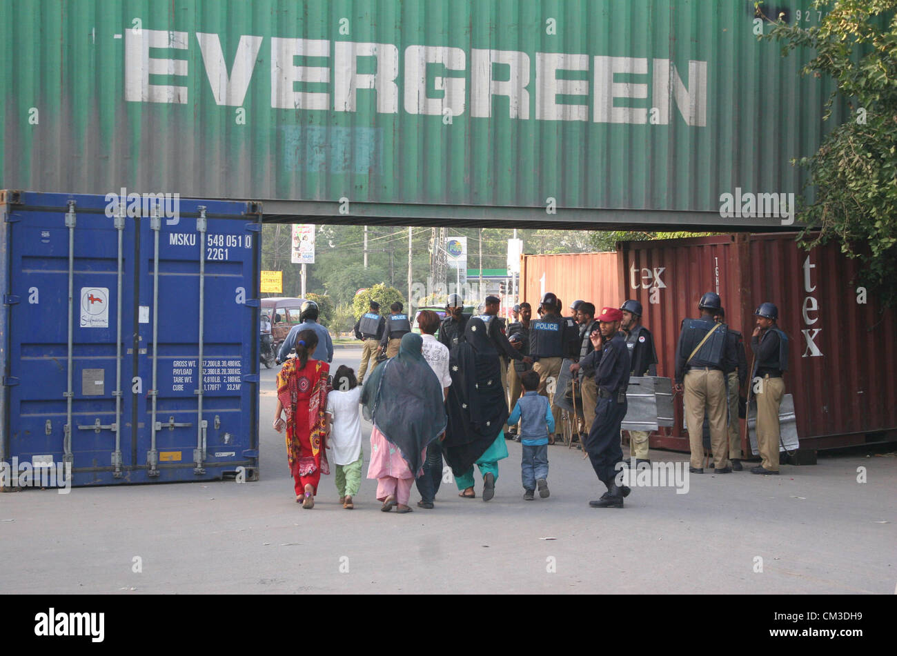 People pass through temporary security gate made with the help of ...