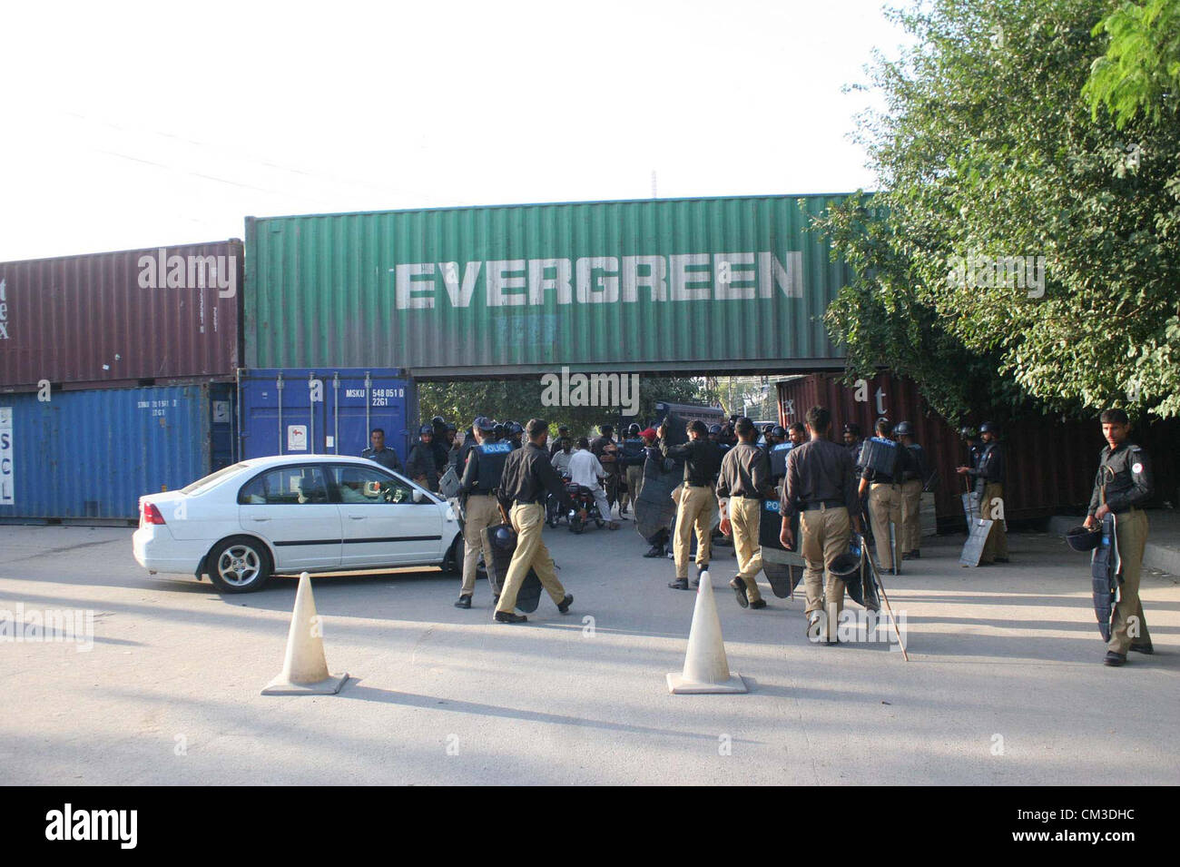 Commuters pass through temporary security gate made with the help of ...