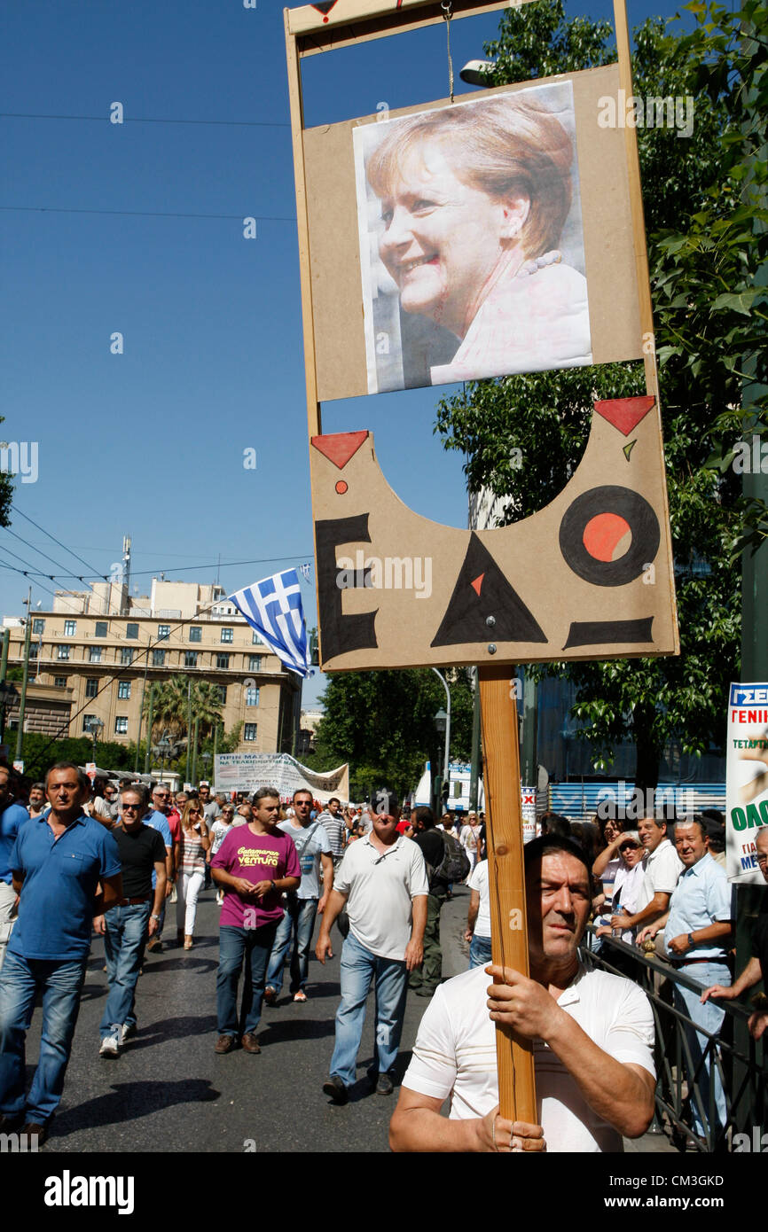 26/09/2012 Athens Greece. Protester hold a guillotine with photo of ...