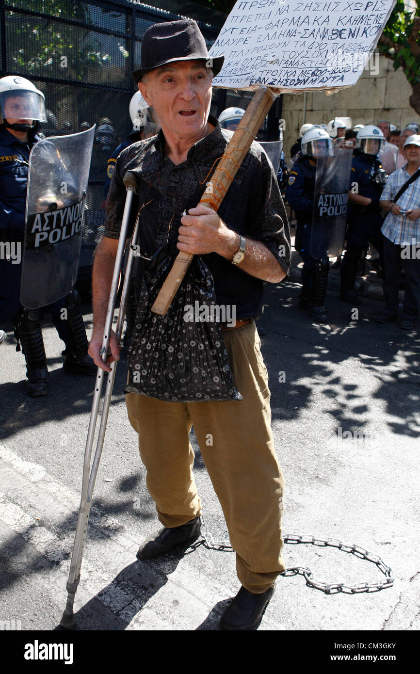 26/09/2012 Athens Greece. A man protests with chained legs outside the ...