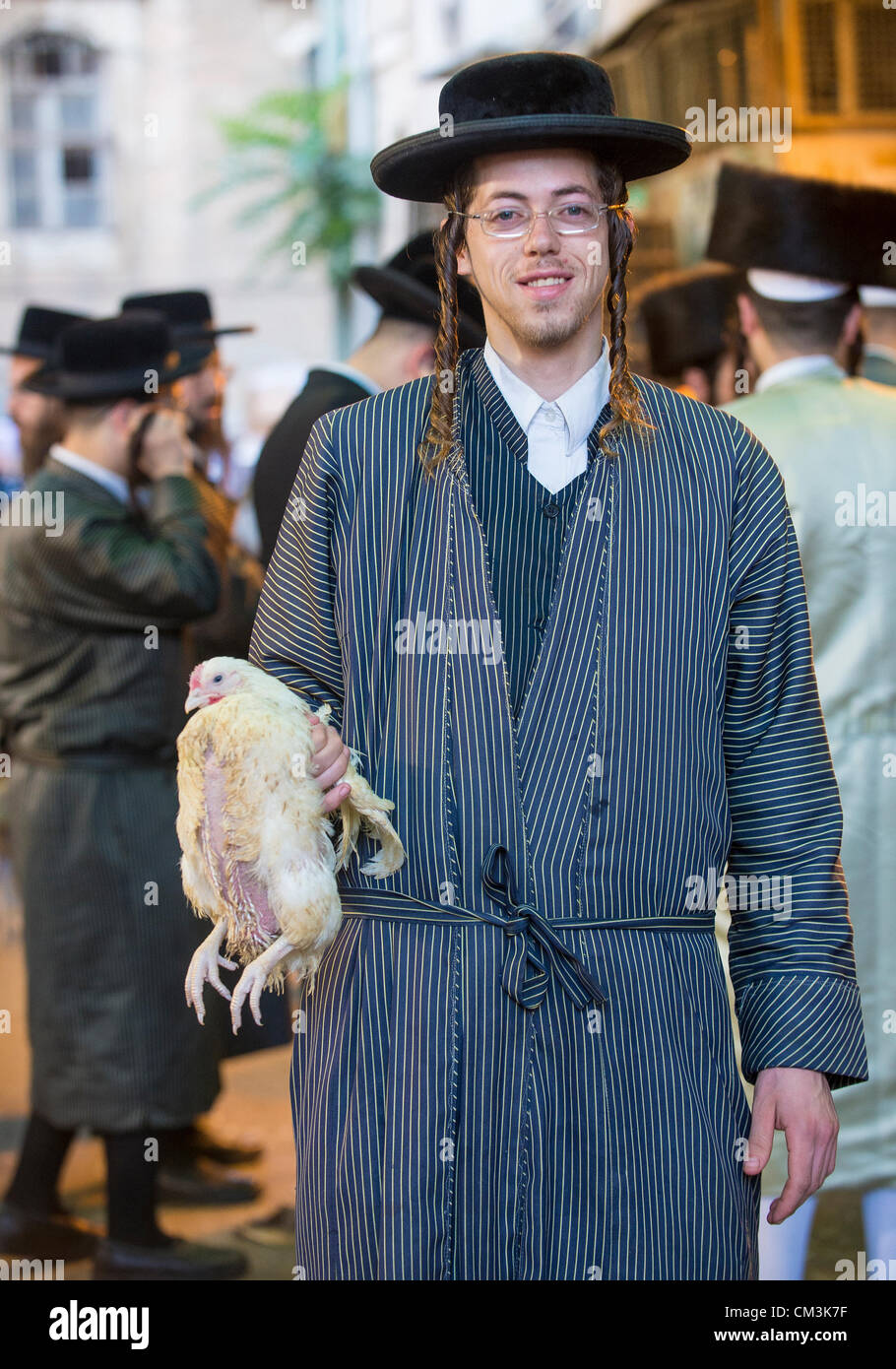 An ultra Orthodox Jewish man holds chicken during the Kaparot ceremony ...