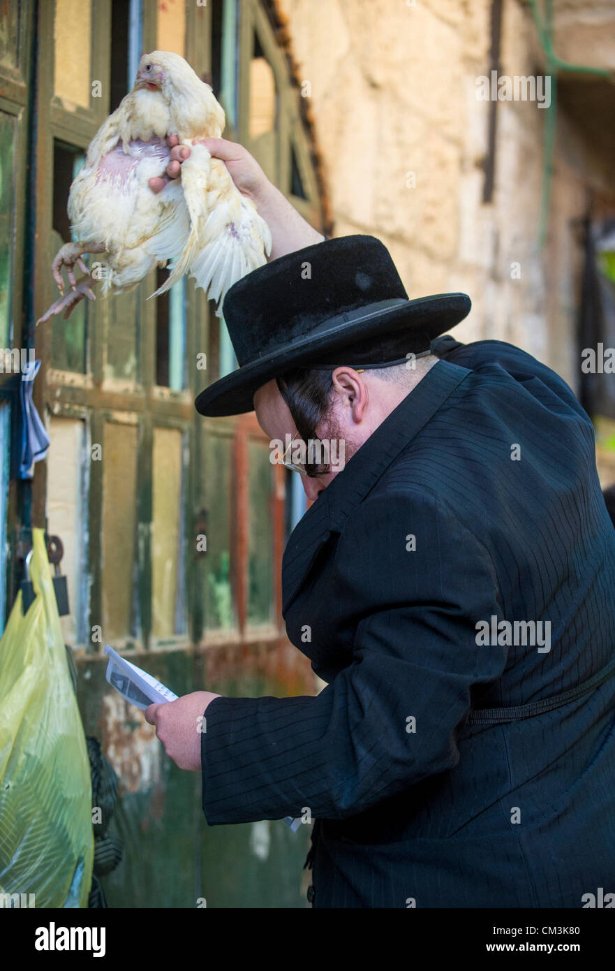 An ultra Orthodox Jewish man waves a chicken over his head during the ...