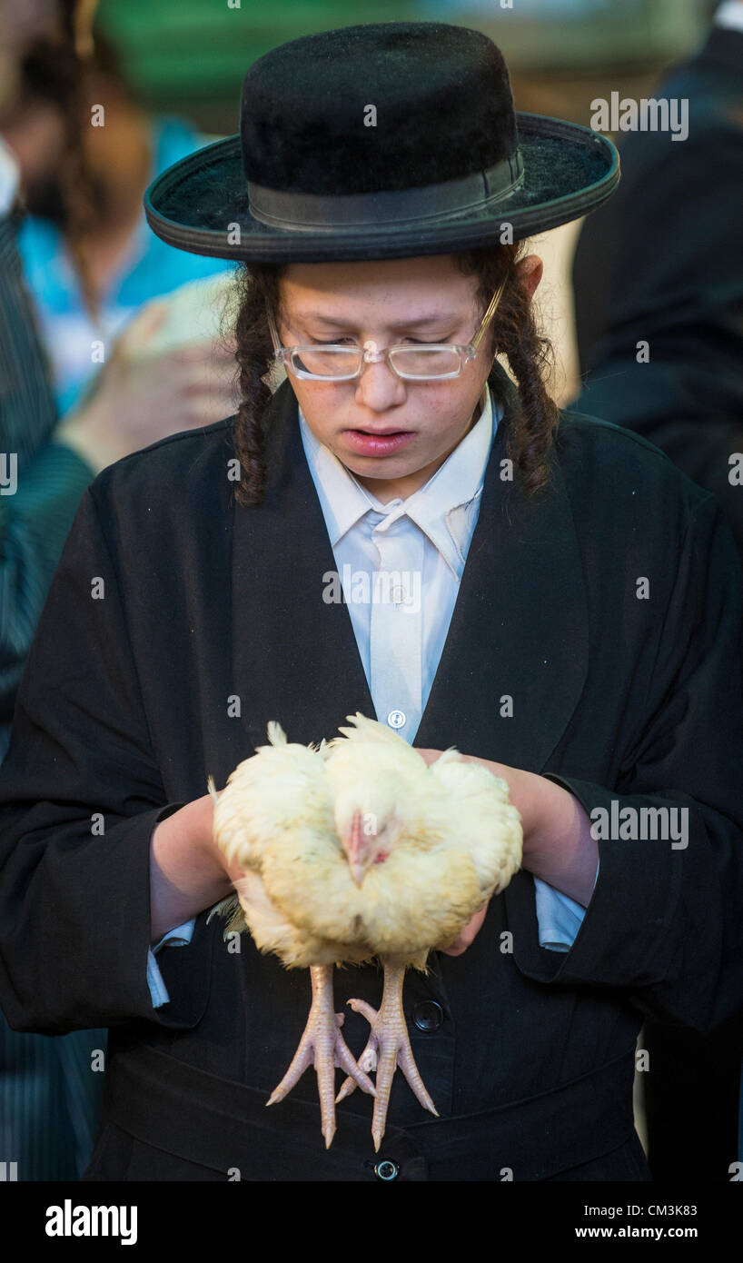 An ultra Orthodox Jewish man holds chicken during the Kaparot ceremony ...