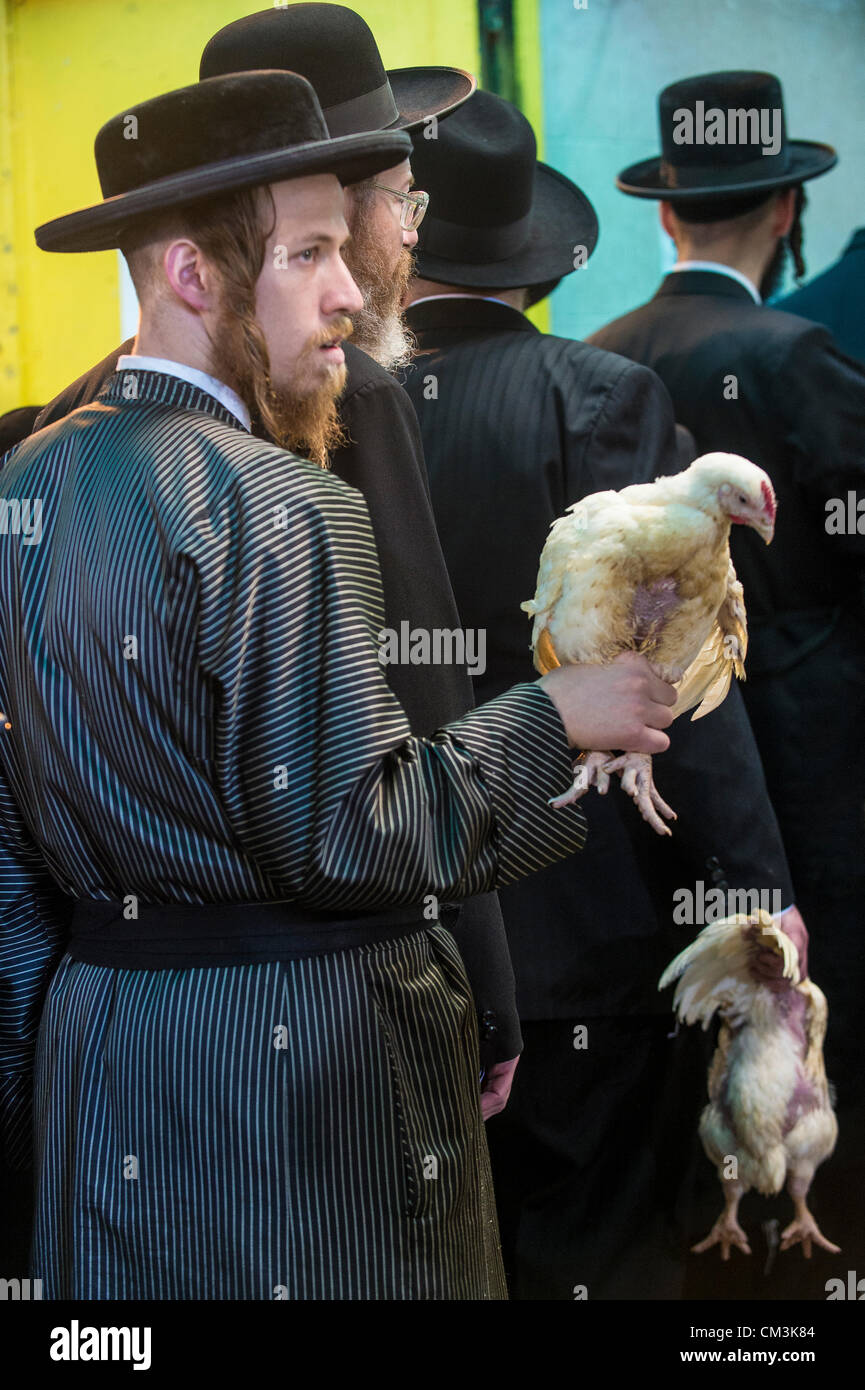 An ultra Orthodox Jewish man holds chicken during the Kaparot ceremony ...