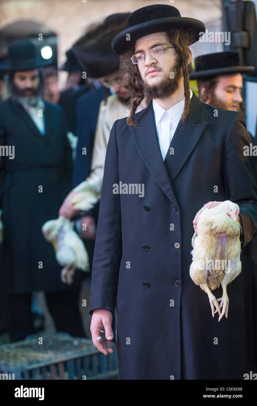 An ultra Orthodox Jewish man holds chicken during the Kaparot ceremony ...