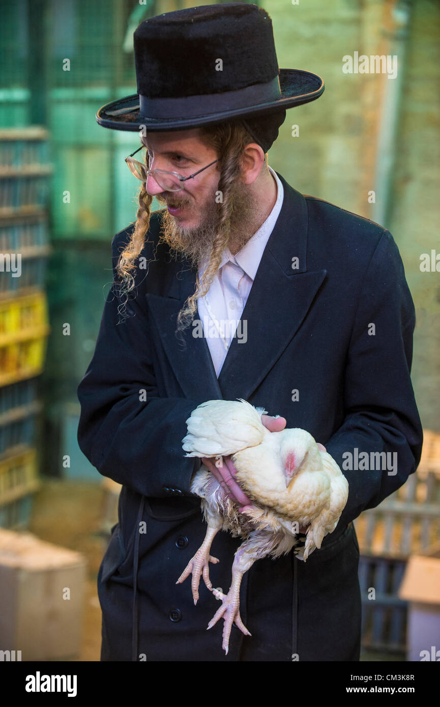 An ultra Orthodox Jewish man holds chicken during the Kaparot ceremony ...