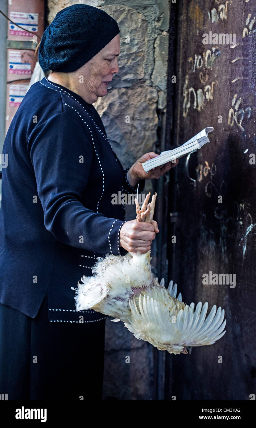 An ultra Orthodox Jewish man prays with a chicken during the Kaparot ...