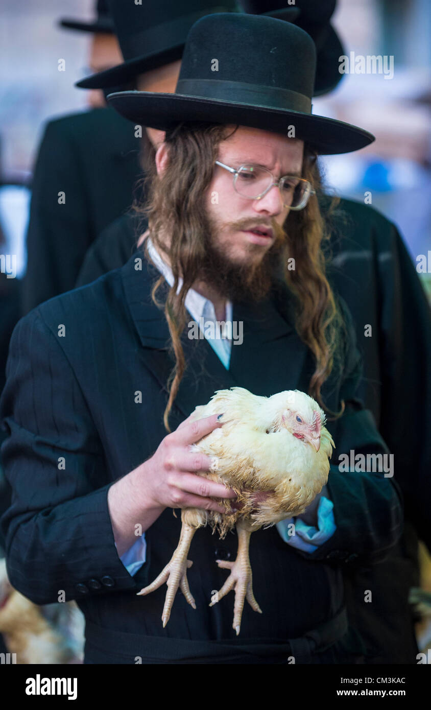 An ultra Orthodox Jewish man holds chicken during the Kaparot ceremony ...