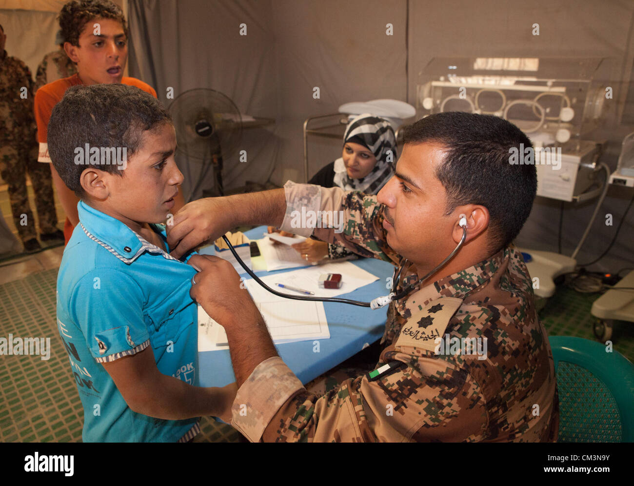 A Syrian boy gets check by a doctor in the Jordanian Italian Field ...