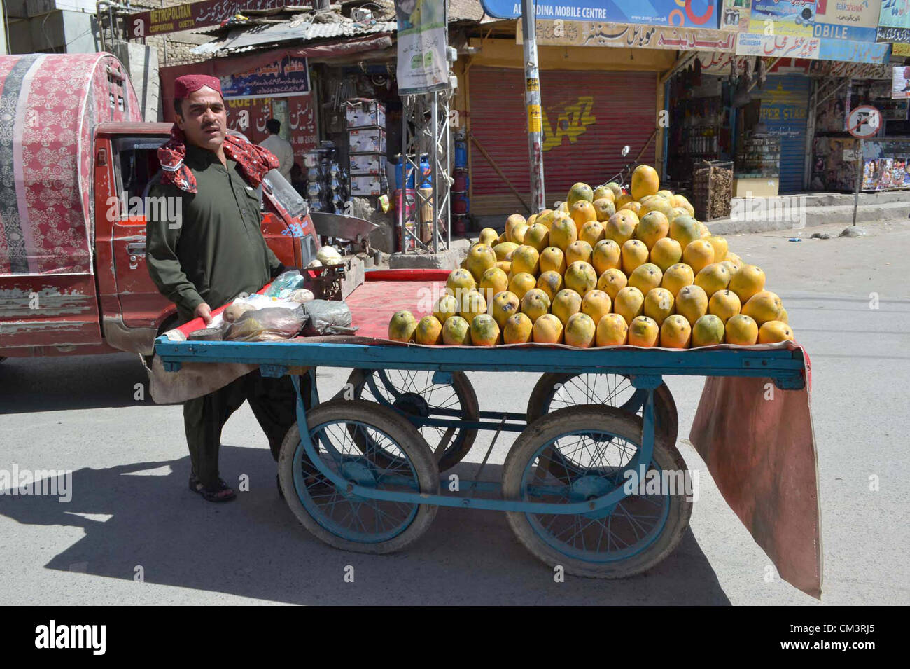 A man sells mango to earn his livelihood for support his family on his ...